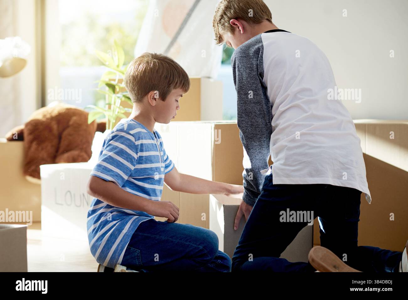 Home, kids and packing toys in cardboard, boxes and helping relocation ...