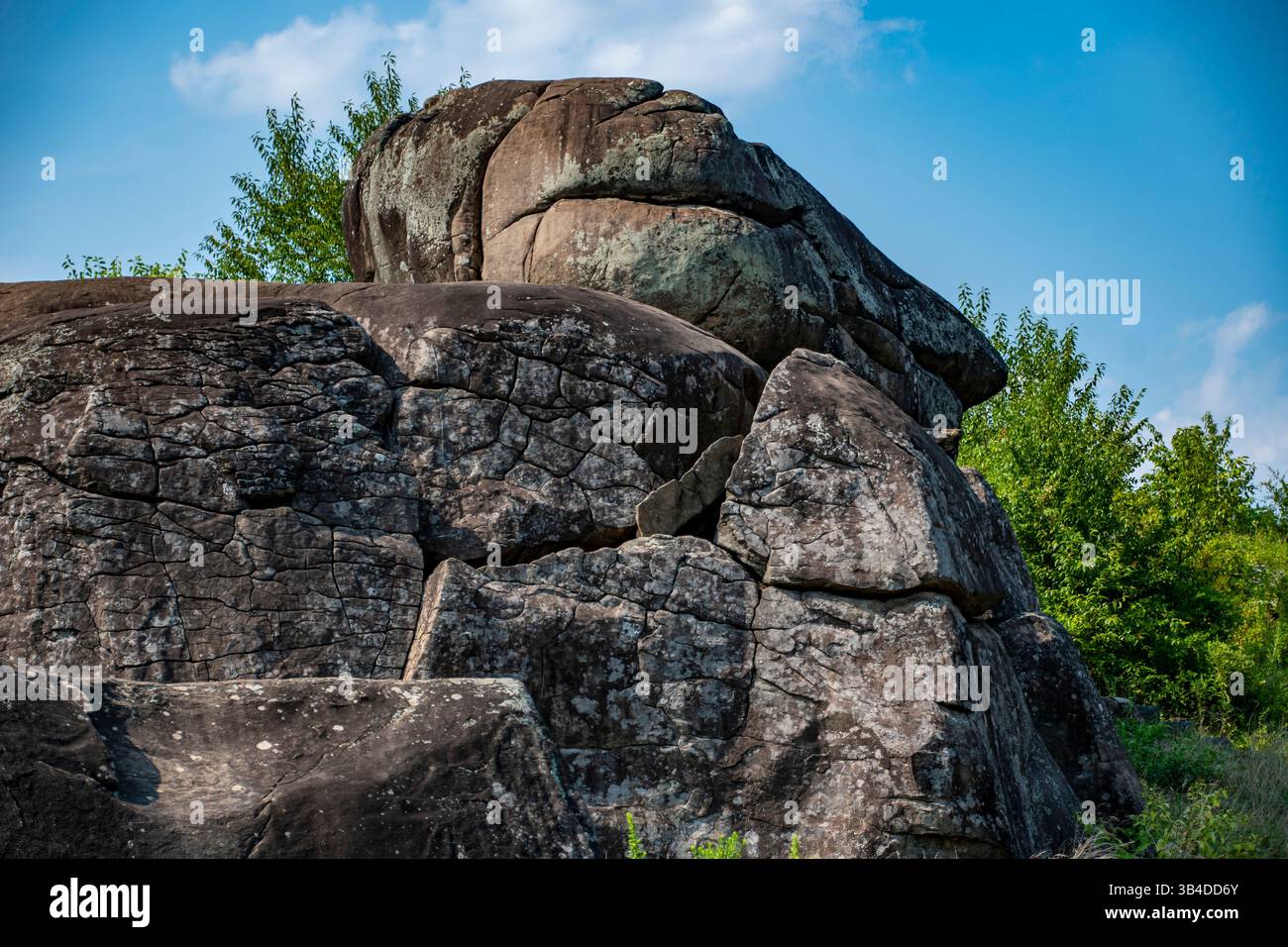 A striking rock formation shaped like a face is prominently displayed ...