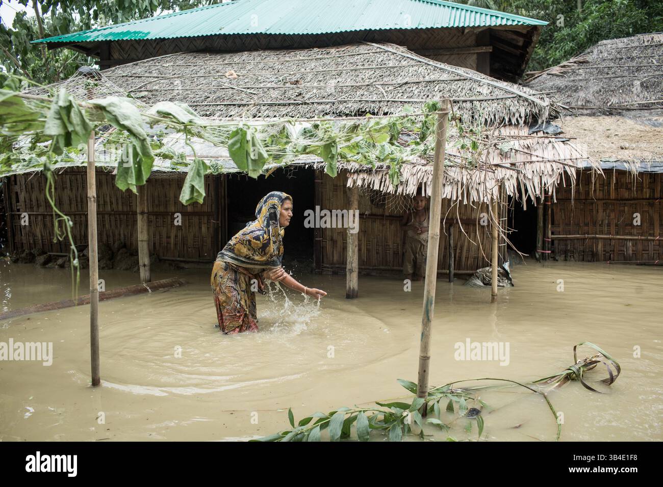 June 28, 2015 - a woman in front of her flooed home in Ramu..around two ...