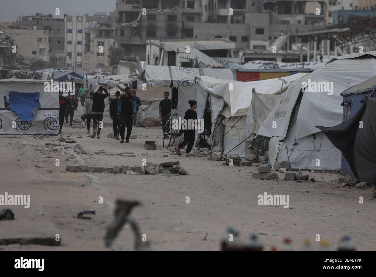 Palestinians walk amidst dust during a sand storm in Gaza City ...