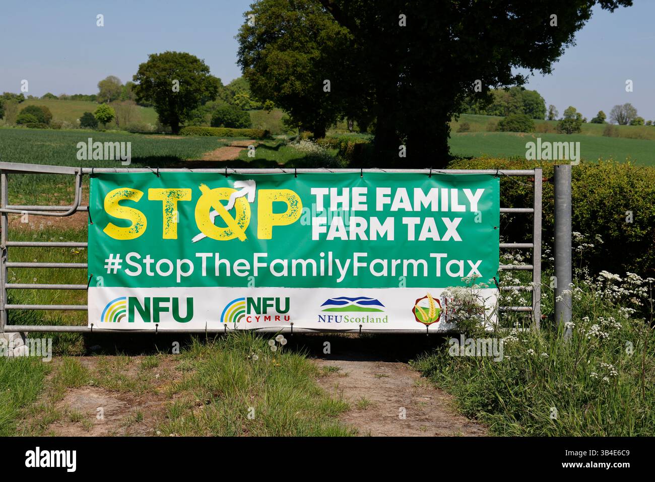 A 'Stop The Family Farm Tax' campaign protest banner, on a field gate ...