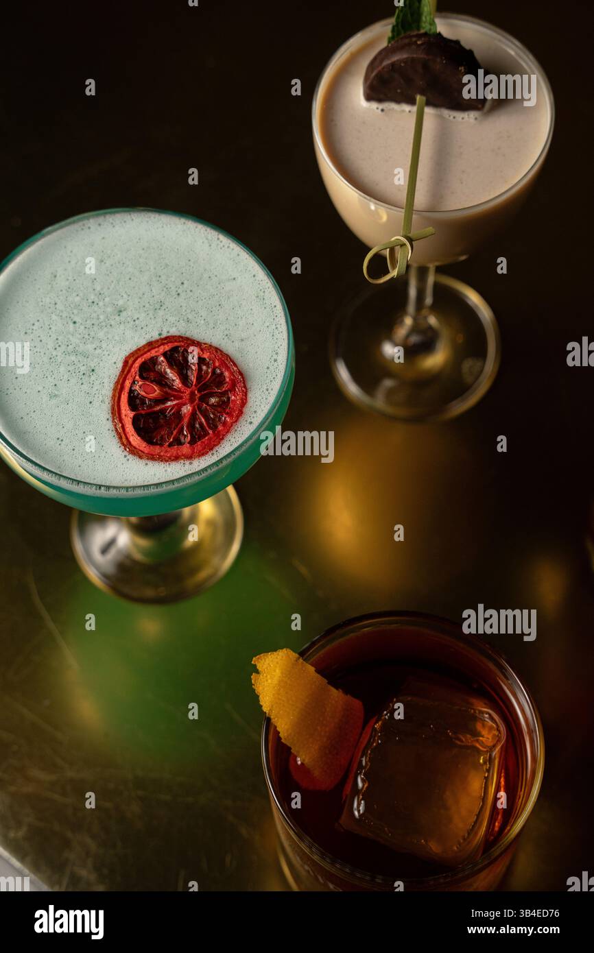 Trio of signature cocktails on reflective bar surface Stock Photo - Alamy