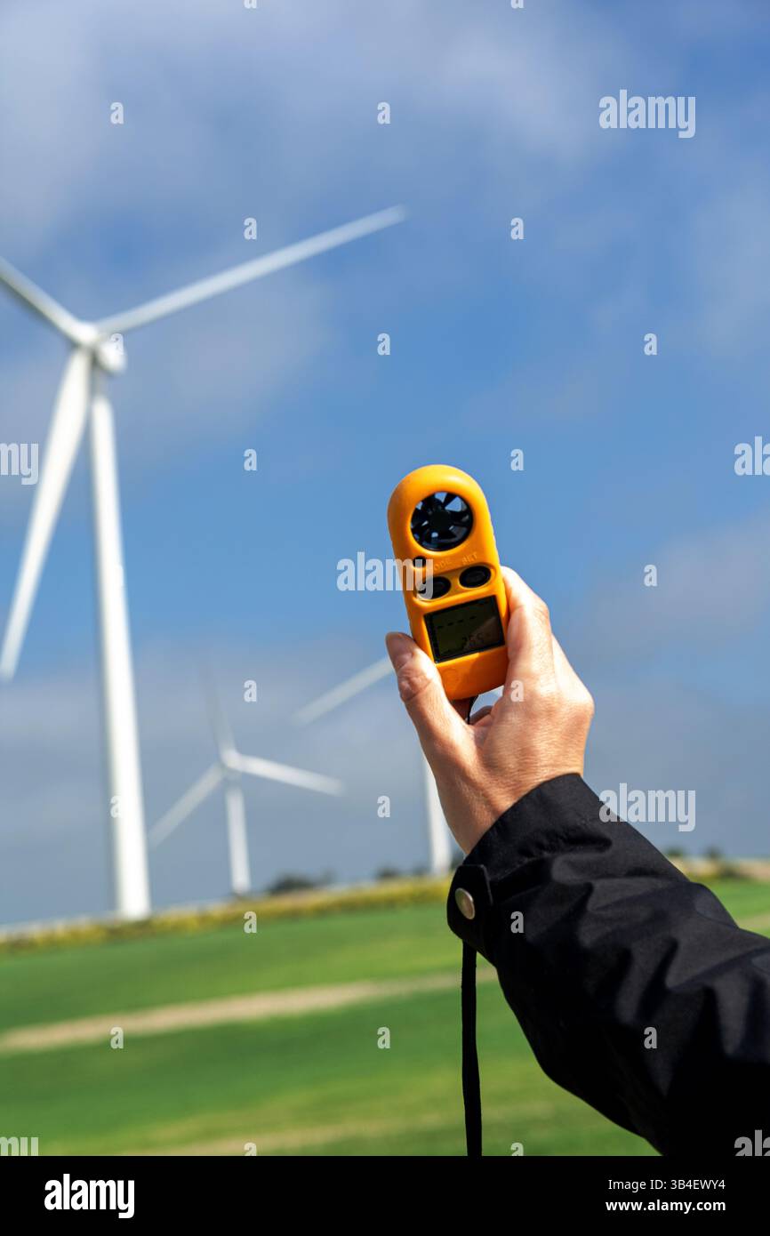 Engineer measuring wind speed for renewable energy with anemometer ...