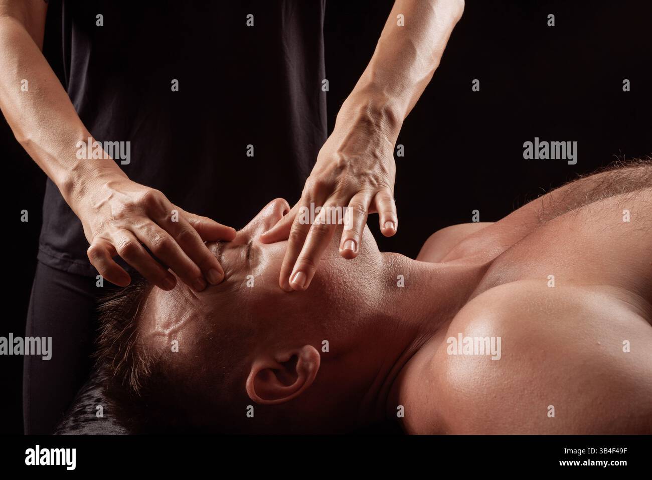 Facial massage therapy session for a man, therapist applying pressure ...