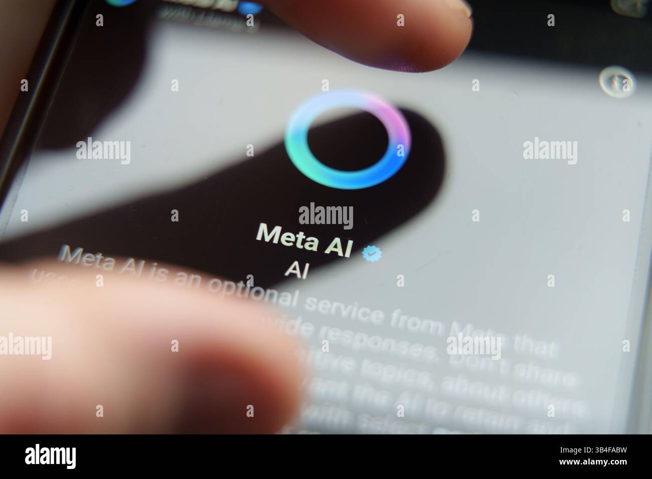 Person using Meta AI chatbot on a smartphone screen, showing logo and ...