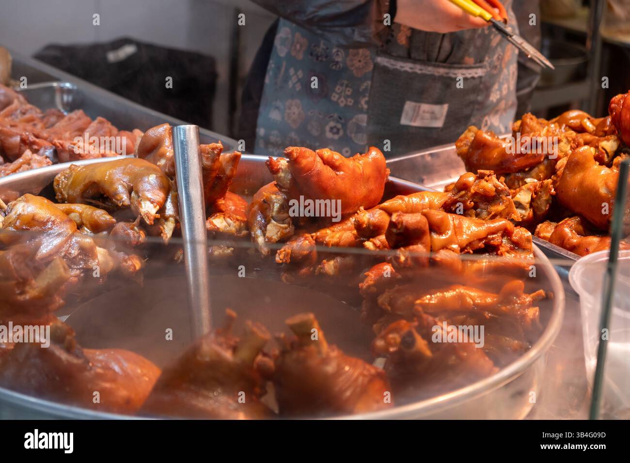 China, Xitang. March 29, 2025. Pork trotters, pig feet at a street food ...