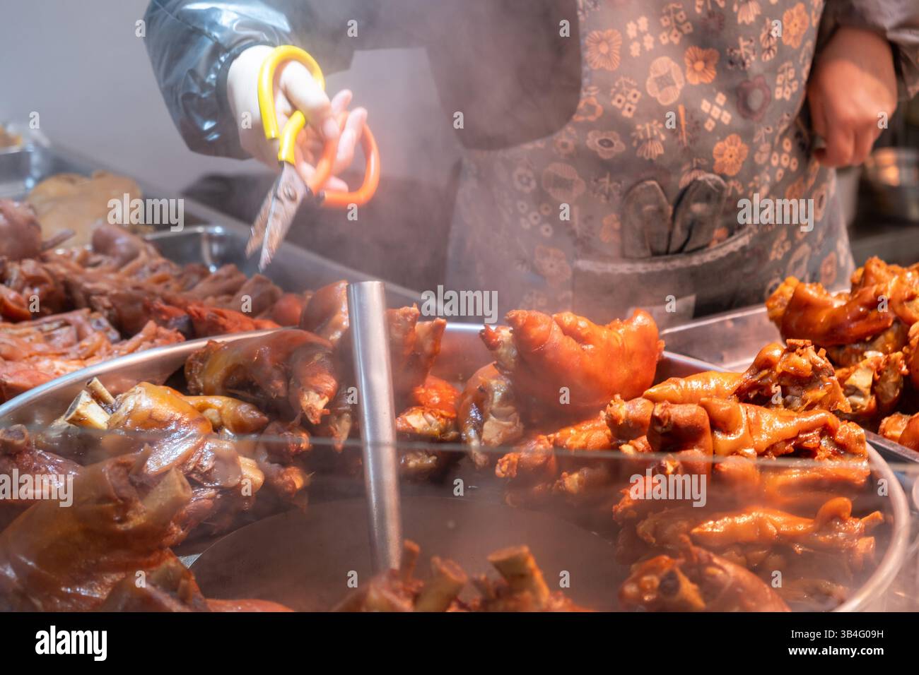 China, Xitang. March 29, 2025. Pork trotters, pig feet at a street food ...