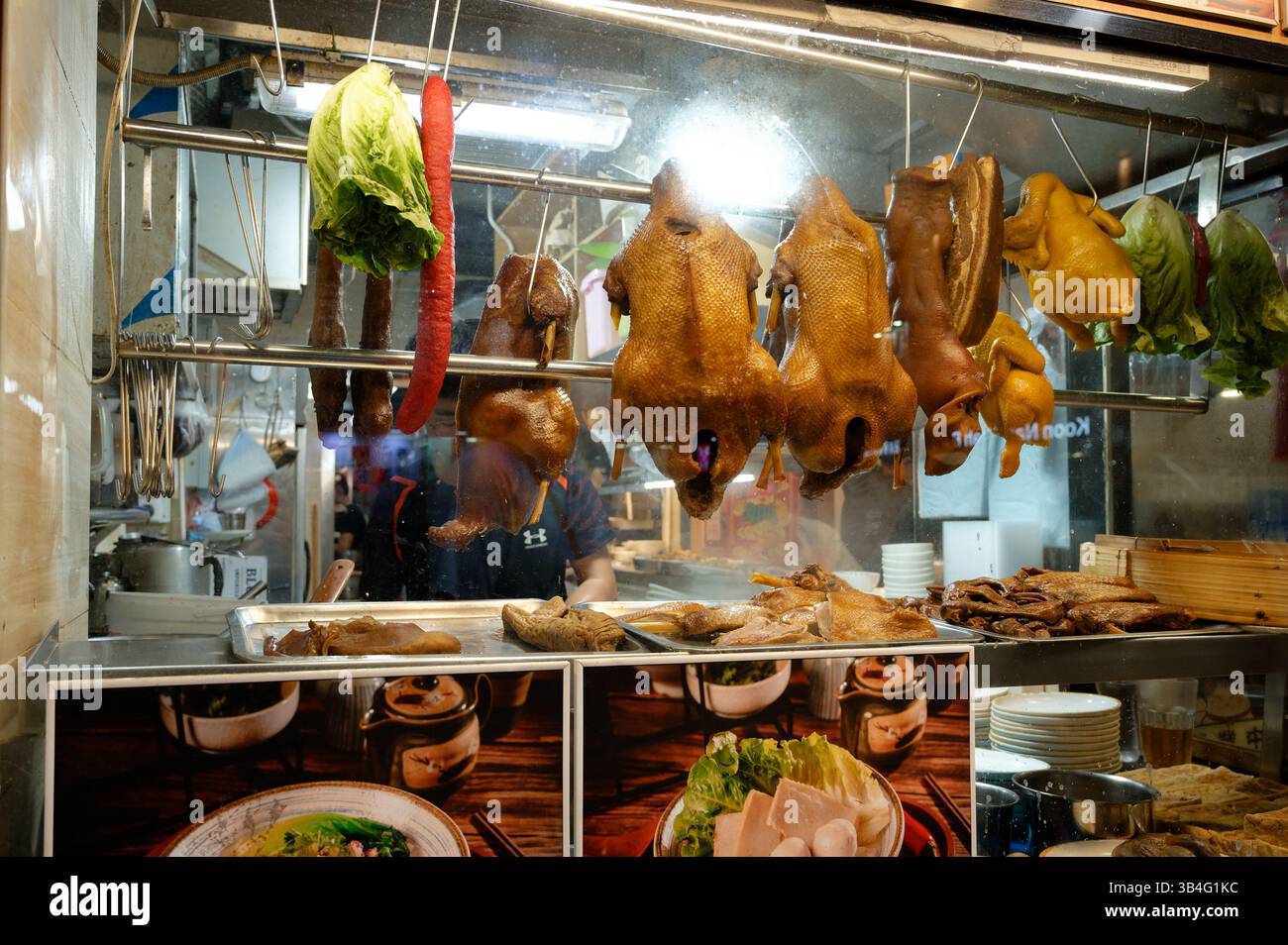 Traditional Cantonese roasted meats hanging in a restaurant window ...