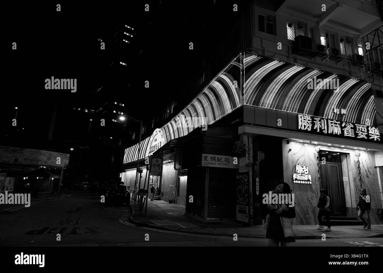 Black and white street view of a neon-lit building corner signage Stock ...