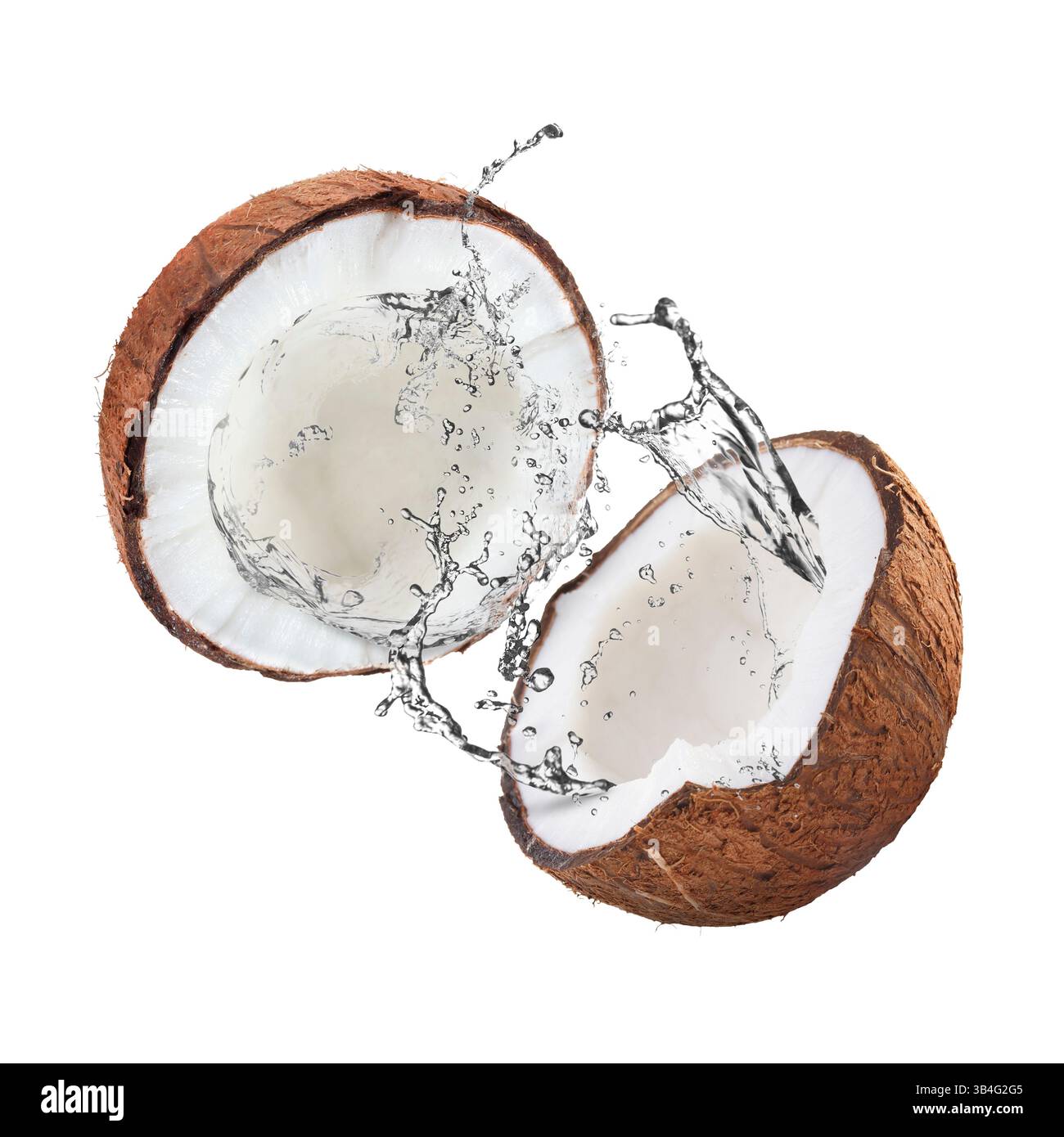 Coconut water splashing out of nut on white background Stock Photo - Alamy