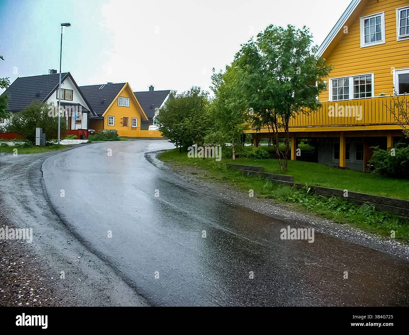 small houses along a winding, wet street in Norway Stock Photo - Alamy