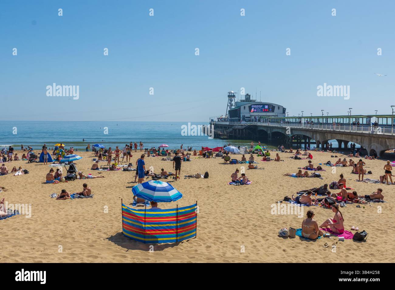 East Cliff Beach, Bournemouth, UK - April 30th 2025: People sunbathing ...