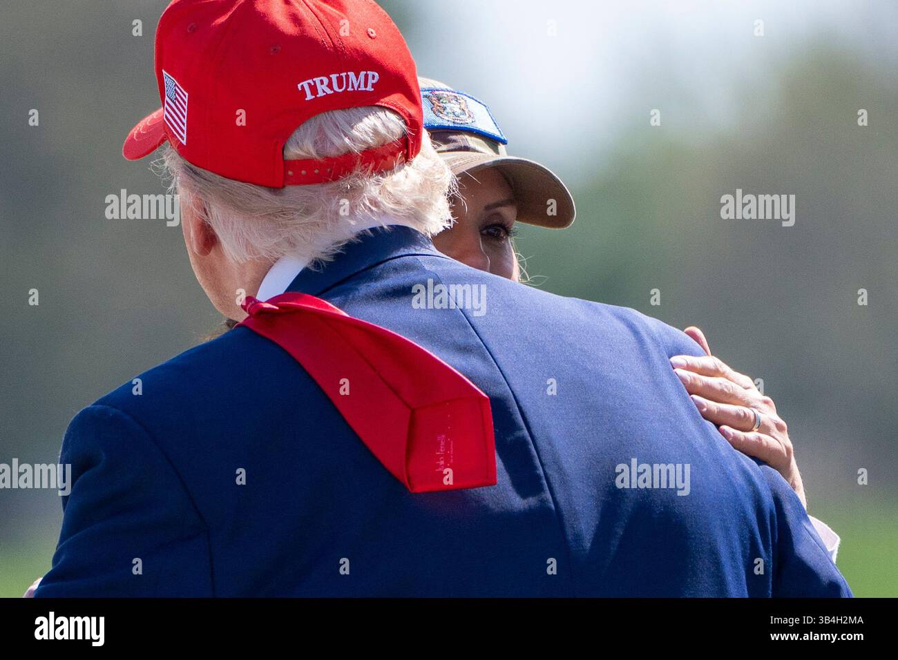 President Donald Trump hugs Michigan Gov. Gretchen Whitmer as he arrives on Air Force One at ...
