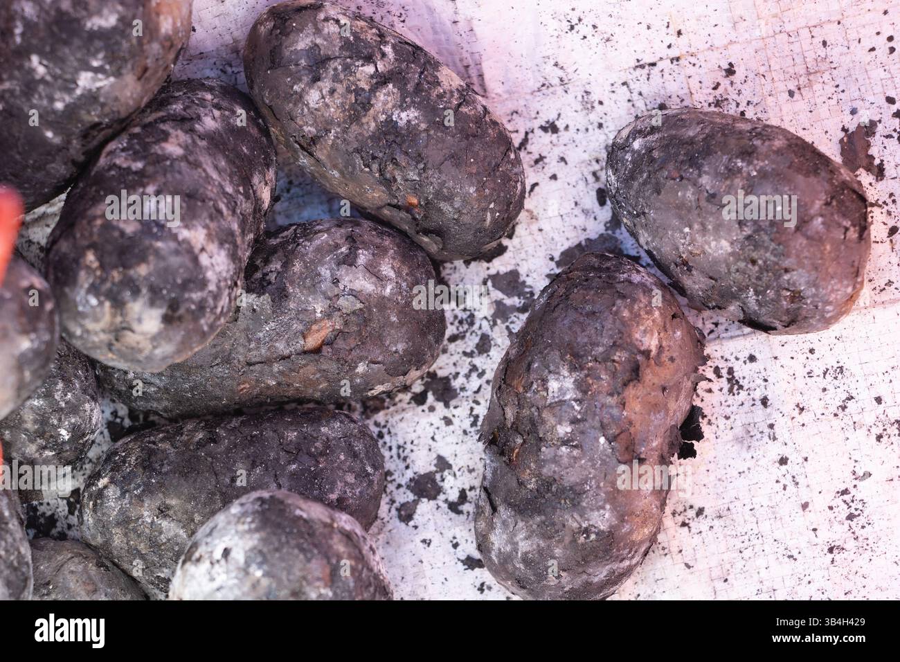 Charcoal-Baked Potatoes Covered in Ash and Ember Residue Stock Photo ...