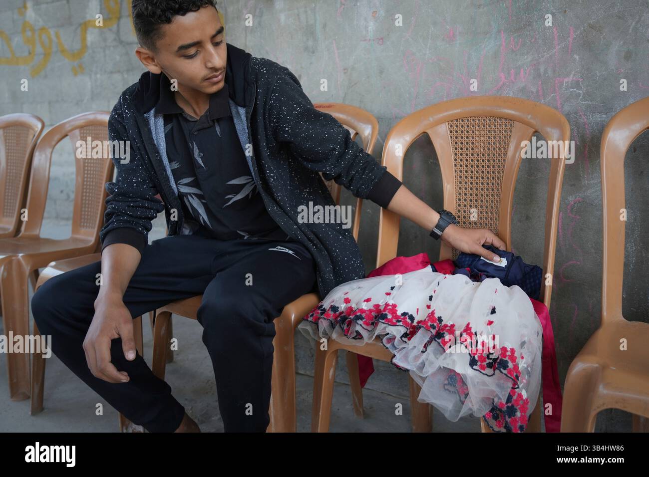 Mohammed Abed shows on Tuesday, April 29, 2025, the dress that his 4 ...