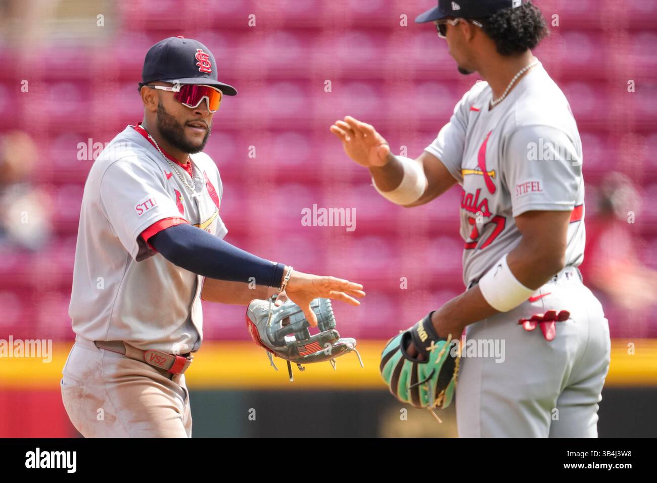 St. Louis Cardinals' Victor Scott II, left, celebrates with Jose ...