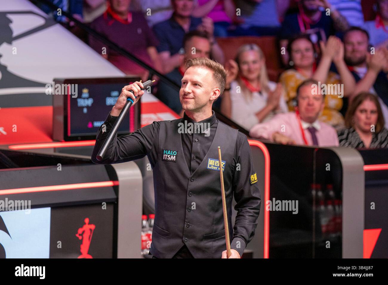 Judd Trump puts his fist in the air after defeating Luca Brecel 13-8 ...