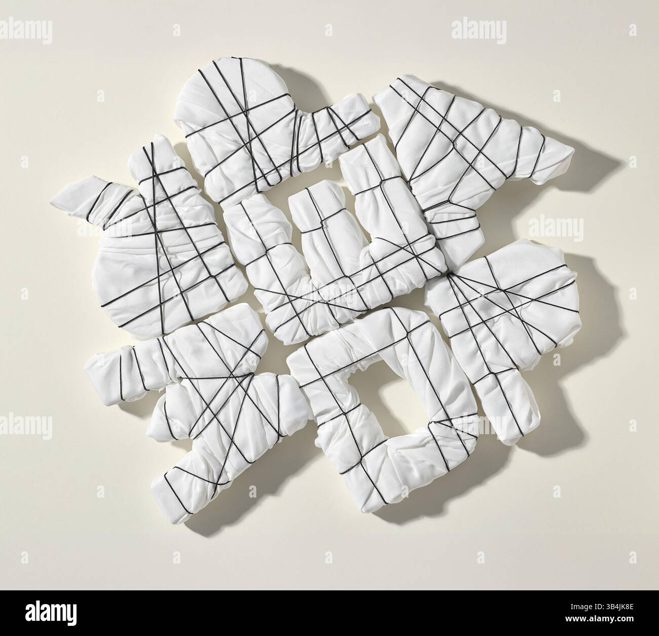 various wrapped in fabric letters on beige background, top view Stock ...