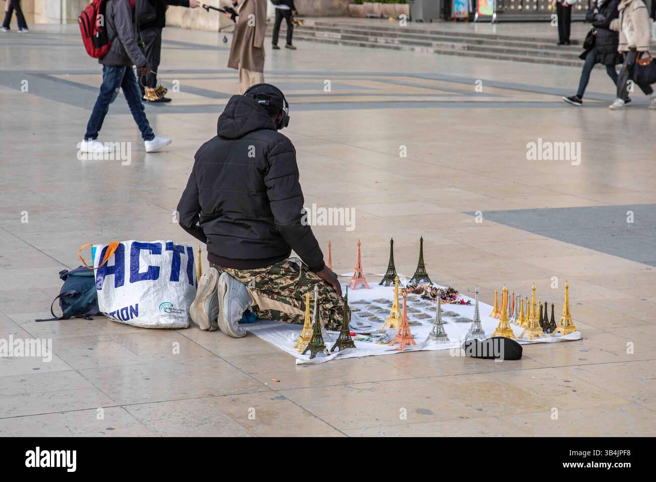 Street vendor selling souvenir miniature Eiffel Towers at Place du ...