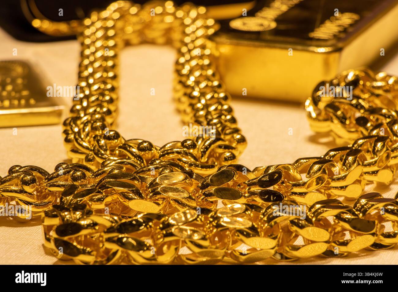Thick and heavy gold chain jewelry and gold bars. Wealth, luxury and ...