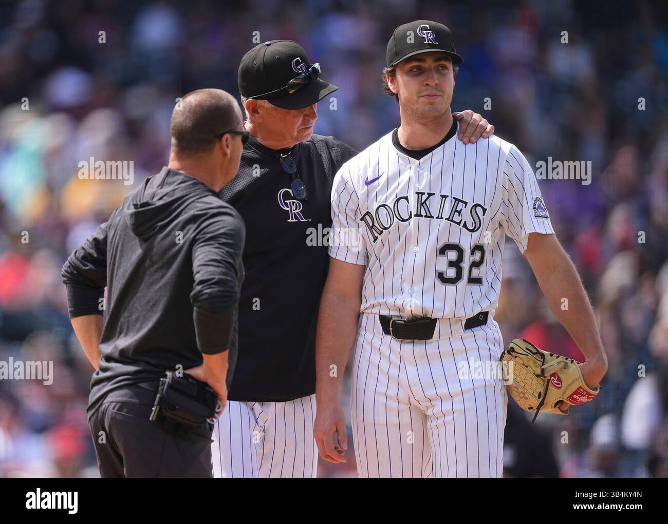 Colorado Rockies starting pitcher Chase Dollander, right, is consoled ...
