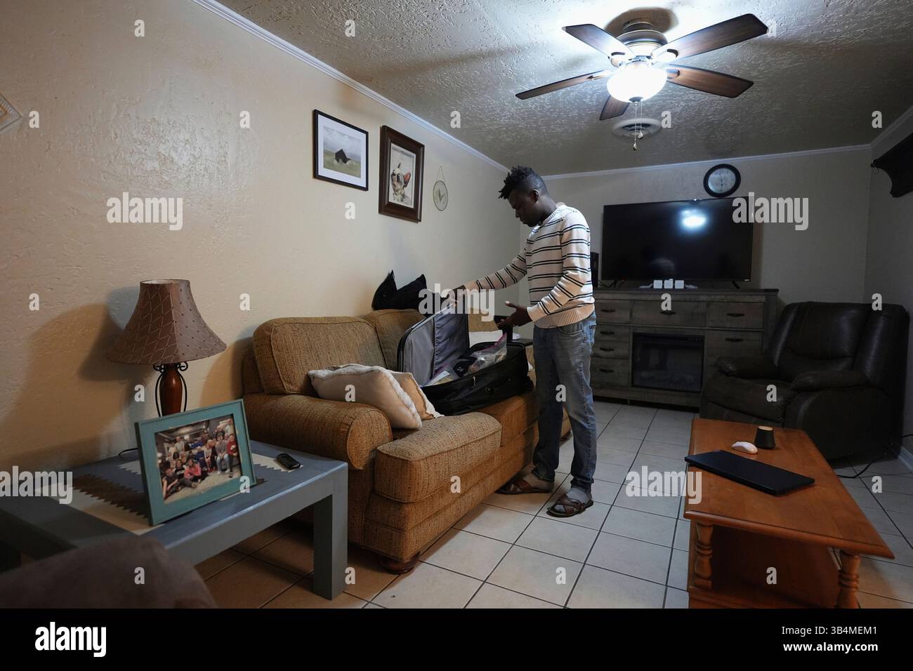 Haitian immigrant Kevenson Jean, a truck driver, packs for a road trip ...
