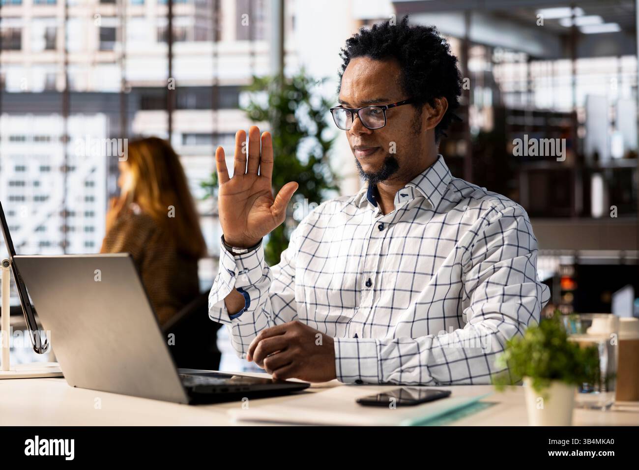 Black man employee joins a telecommuting session at his office desk ...