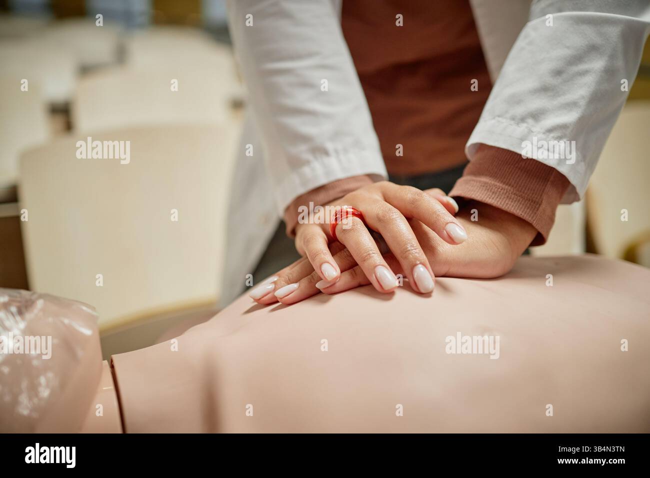 Young Woman Performing Chest Compressions in CPR Training Stock Photo ...