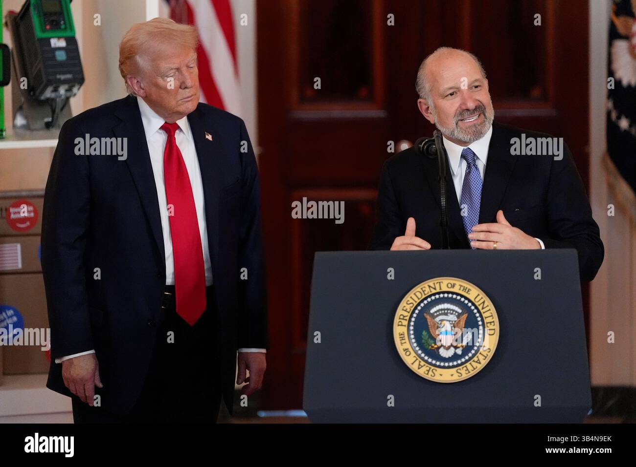 President Donald Trump listens as Commerce Secretary Howard Lutnick ...
