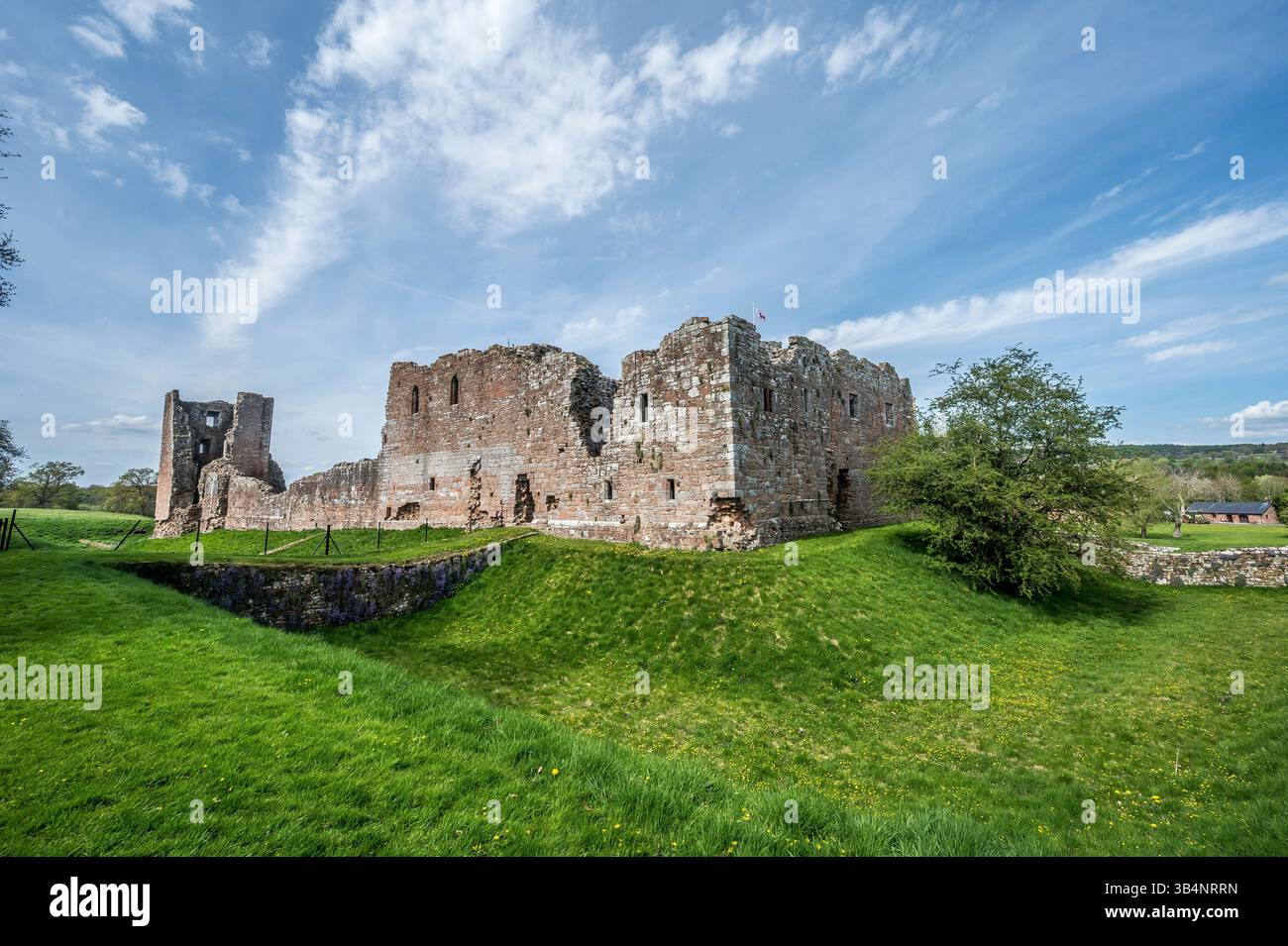 The image is of the ruins of the external walls, tower and moat at 13th ...