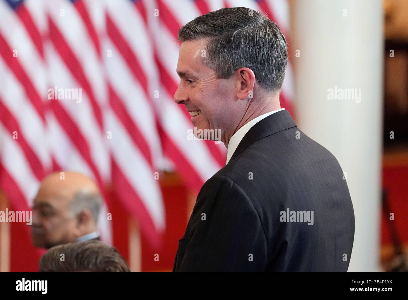 Eli Lilly and Company CEO David Ricks stands as President Donald Trump ...