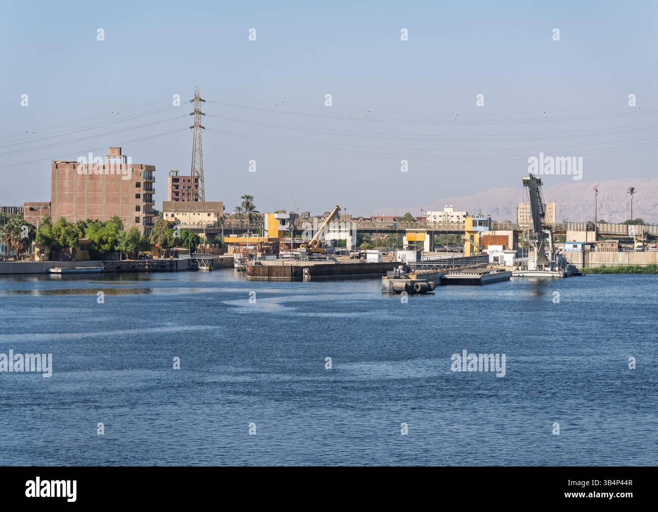 Approaching the new Esna dam and lock on Nile River with gates open for ...