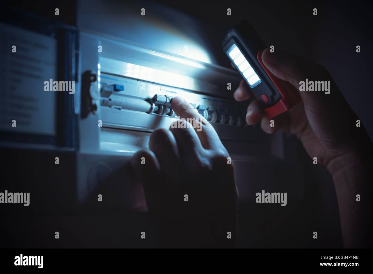 Investigate a home fuse box during a power outage. Blackout concept ...