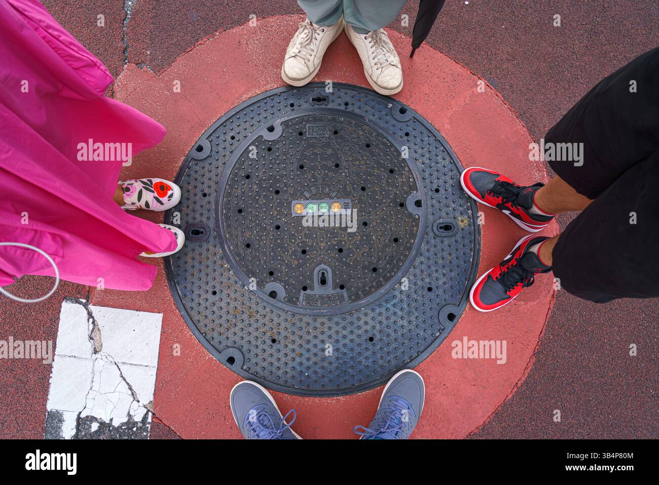 Tokyo, Japan - Sep 30 2024, A close-up view of a manhole surrounded by ...