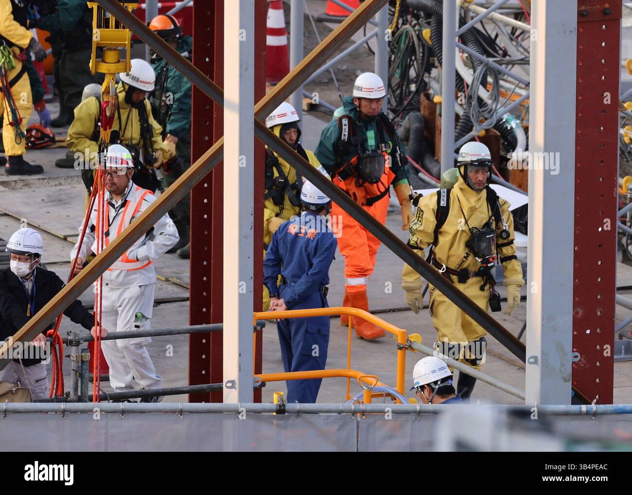 Firefighters investigate inside the sewer pipe at the collapse of an ...