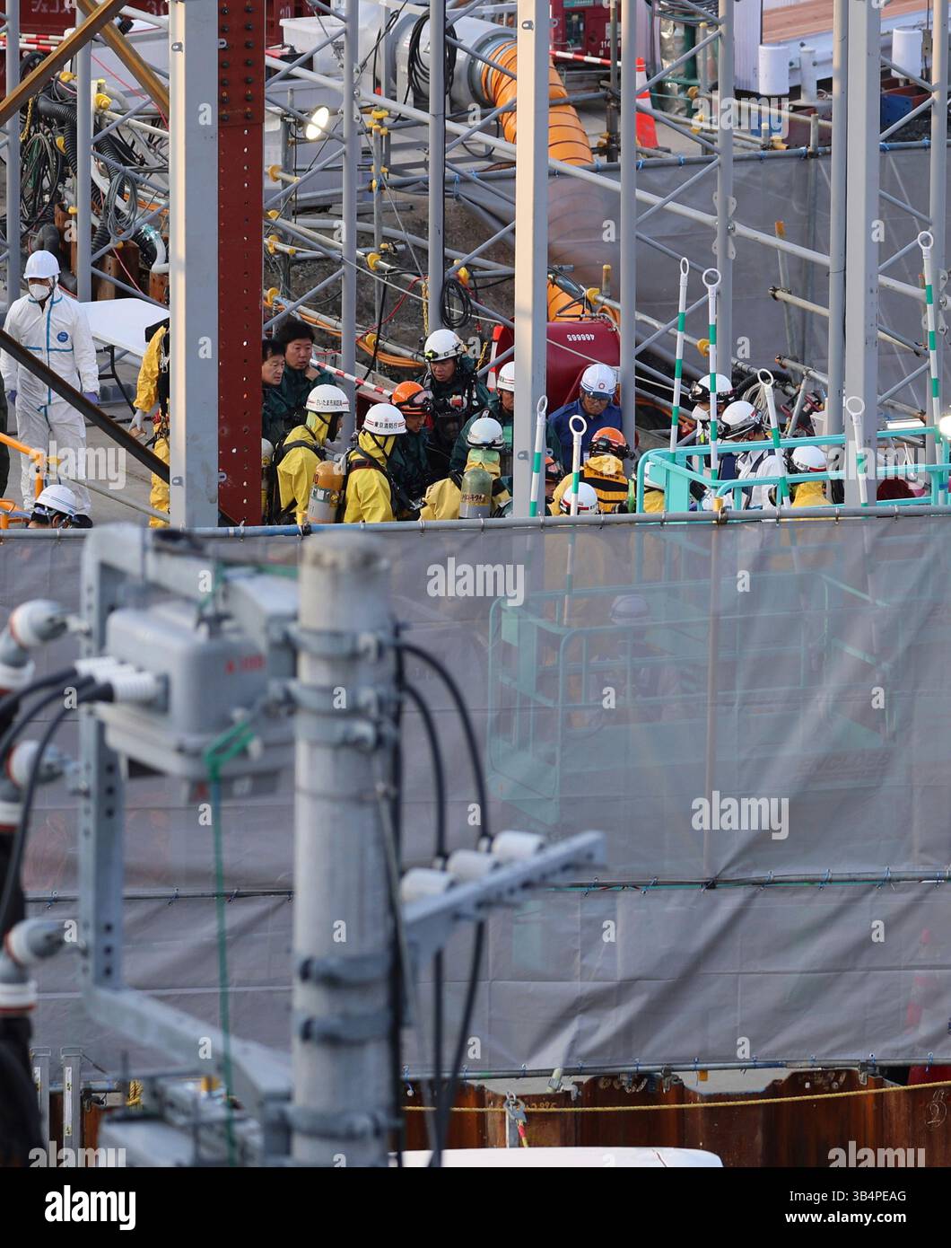 Firefighters investigate inside the sewer pipe at the collapse of an ...