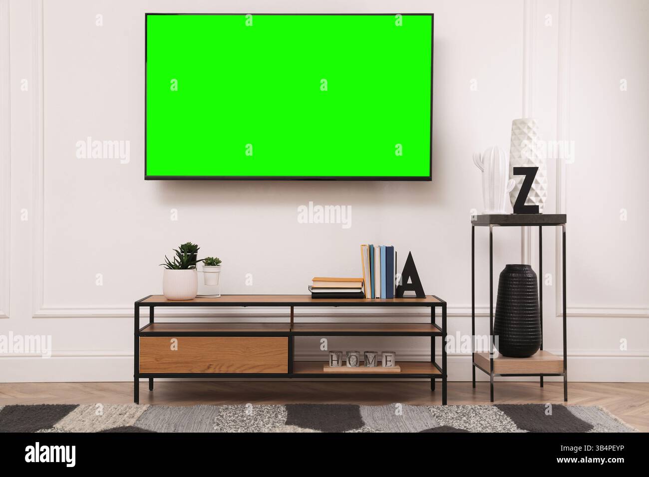 TV set with green screen on white wall in room. Chroma key compositing ...