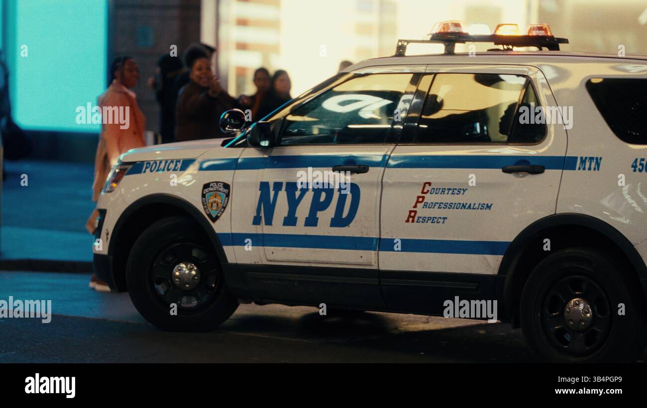 NEW YORK, USA - FEBRUARY 14, 2025 - NYPD police car patrolling Manhattan streets at night Stock ...