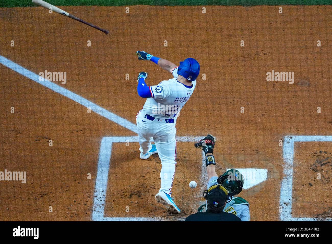Texas Rangers' Jake Burger loses his bat while swinging at a pitch from ...