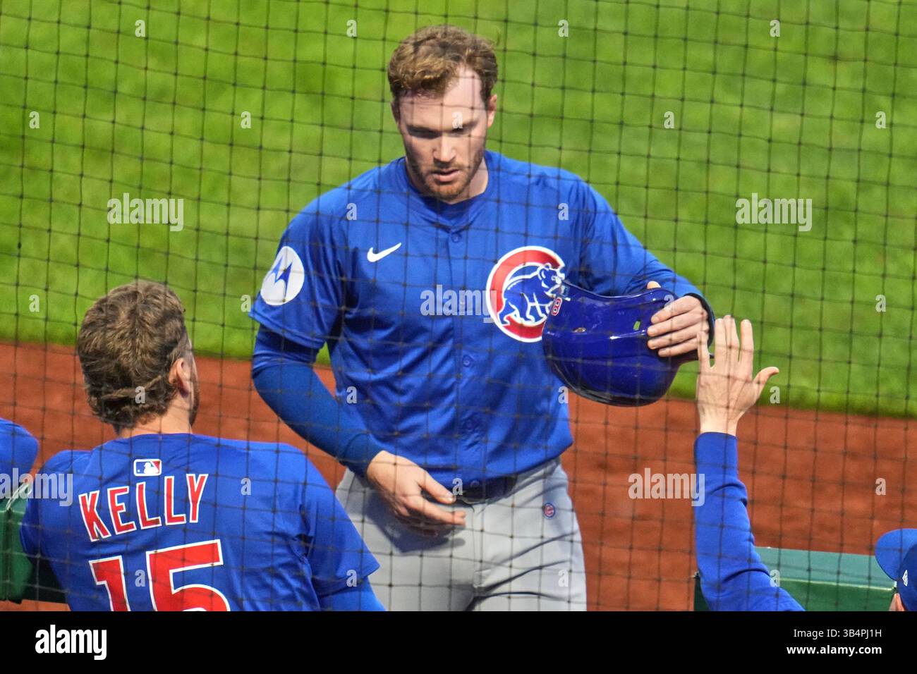 Chicago Cubs' Ian Happ, center, returns to the dugout after scoring on ...