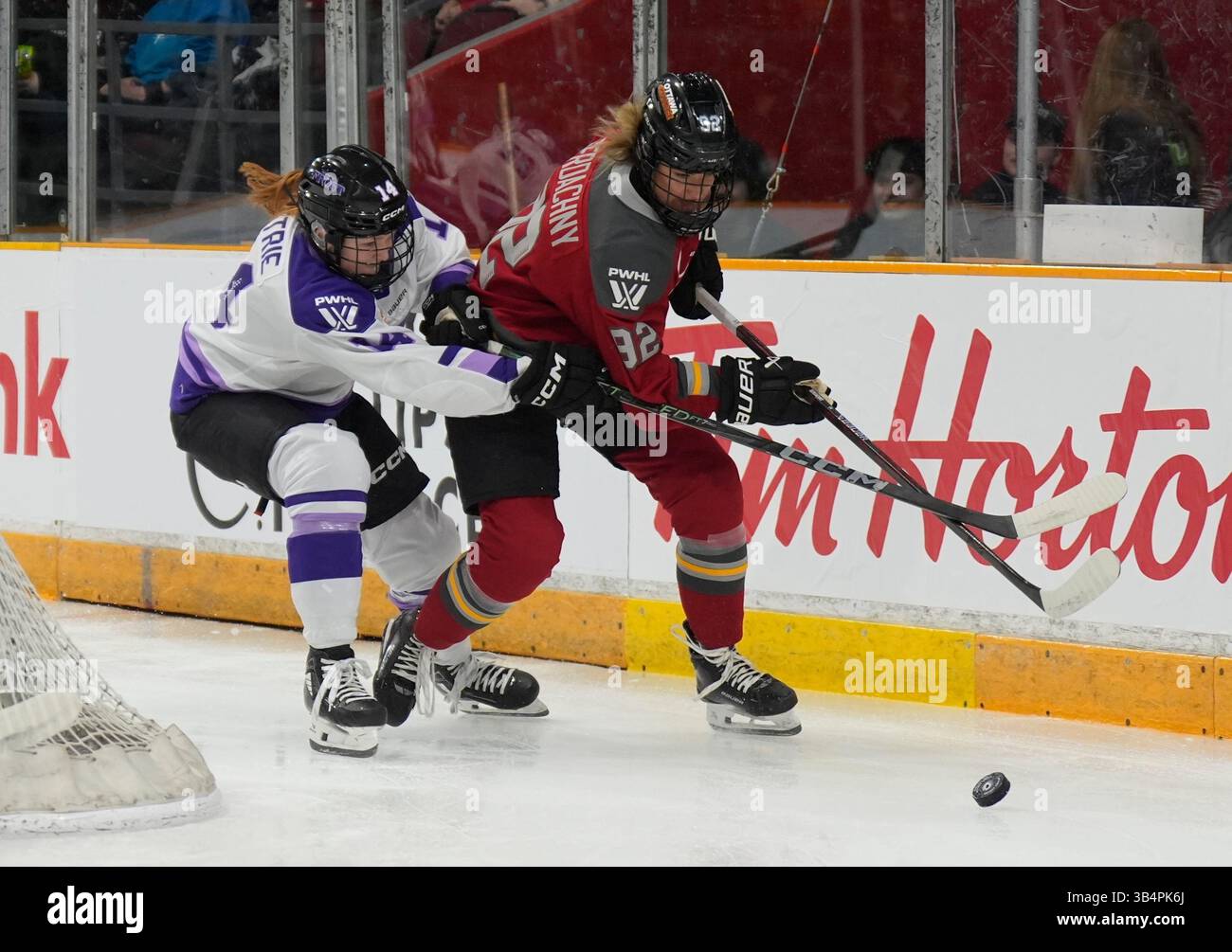 Minnesota Frost forward Dominique Petrie (14) battles Ottawa Charge ...