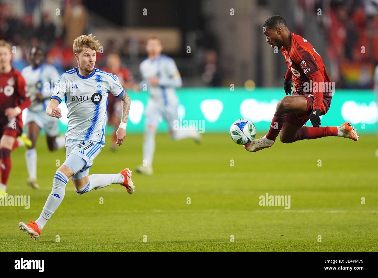 Toronto FC's Tyrese Spicer (right) controls the ball as CF Montreal's ...