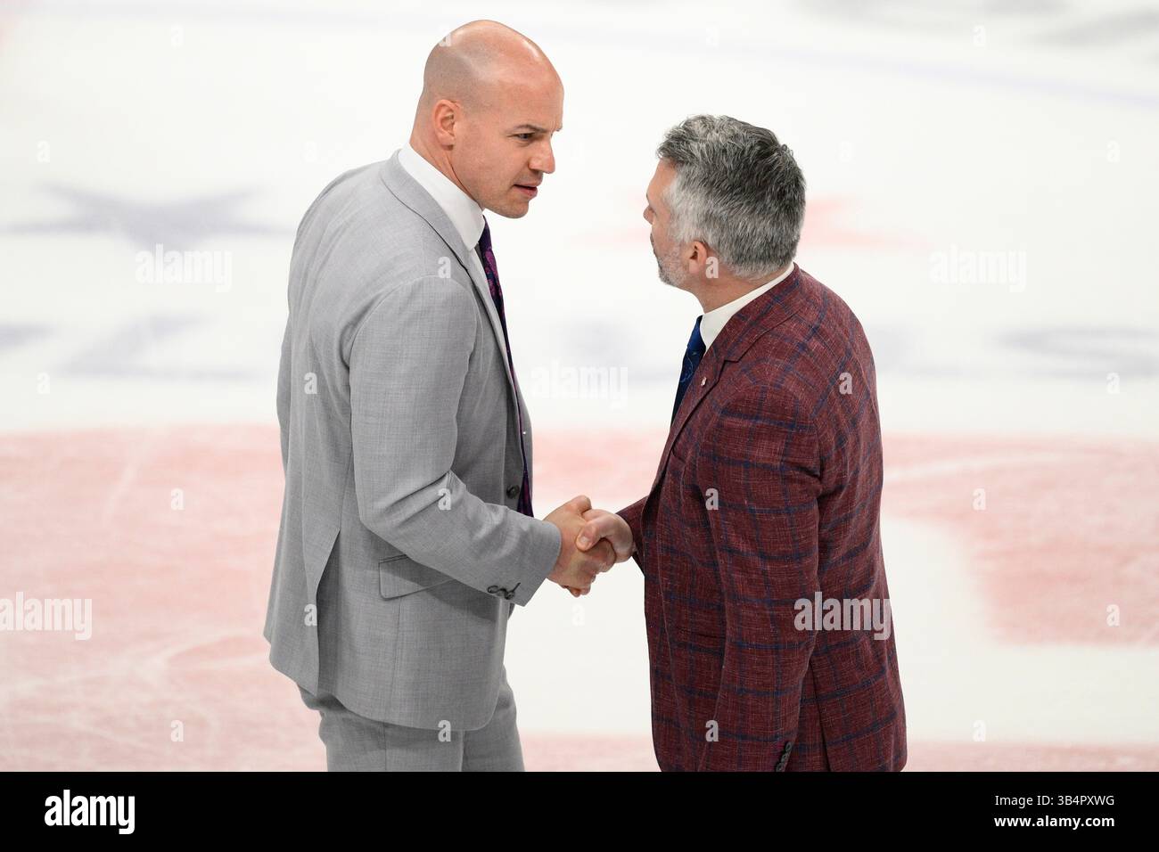 Washington Capitals head coach Spencer Carbery, left, shakes hands with ...