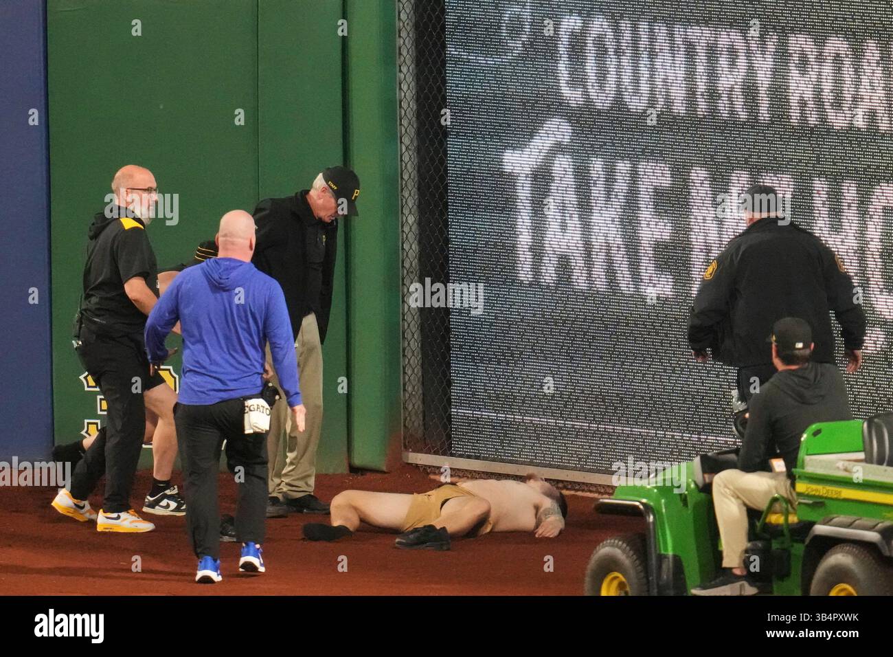 A fan lies on the warning track in right field of PNC Park after ...