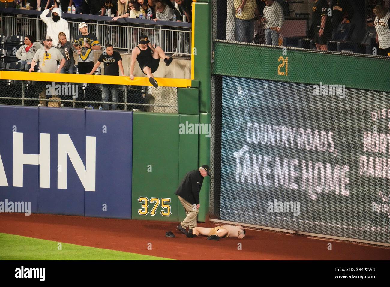 A fan lies on the warning track in right field of PNC Park after ...