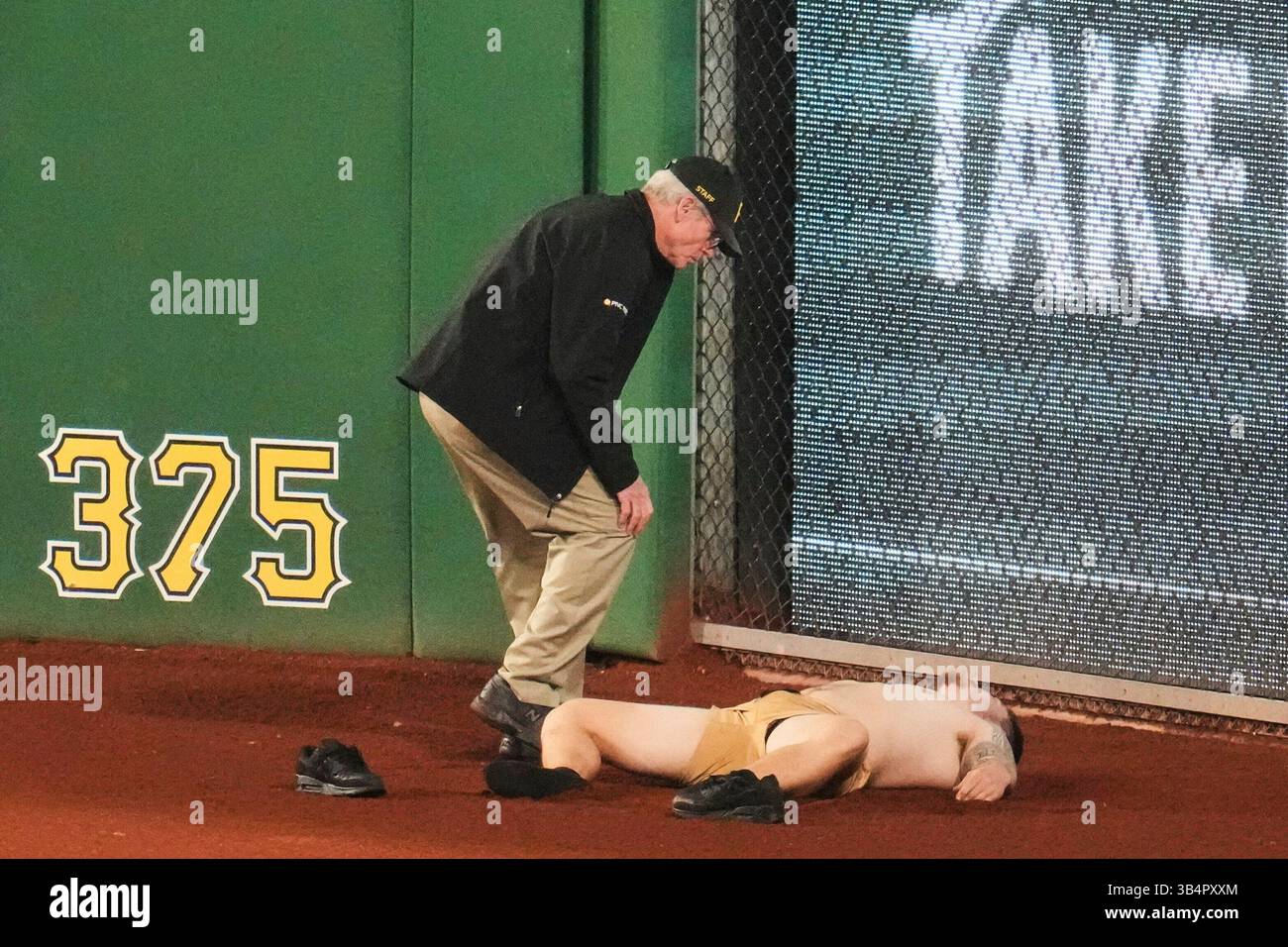 A fan lies on the warning track in right field of PNC Park after ...