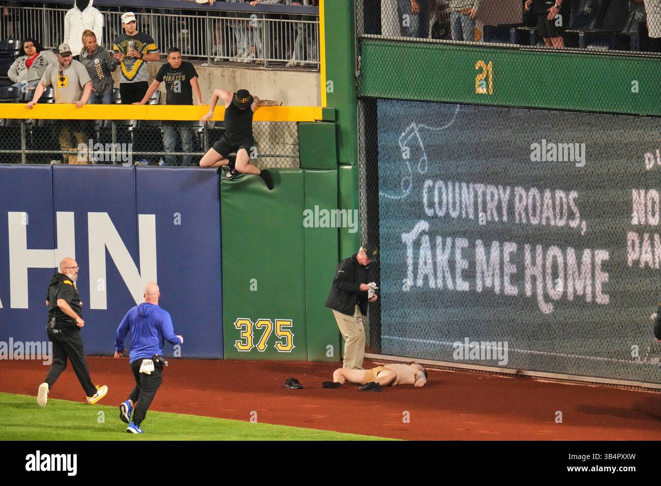 A fan lies on the warning track in right field of PNC Park after ...
