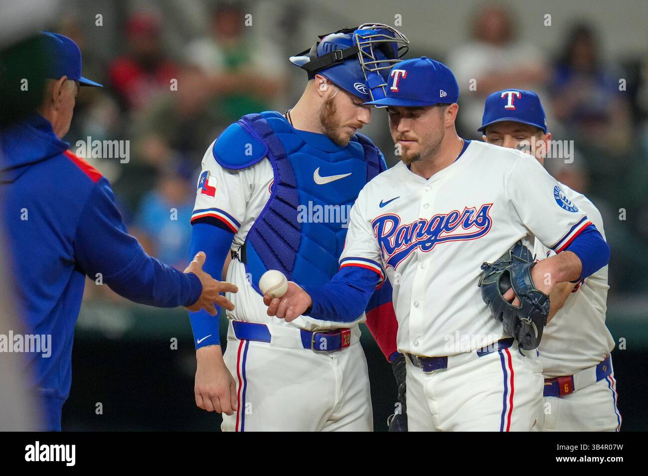 Texas Rangers pitcher Luke Jackson hands off the ball to Manager Bruce ...