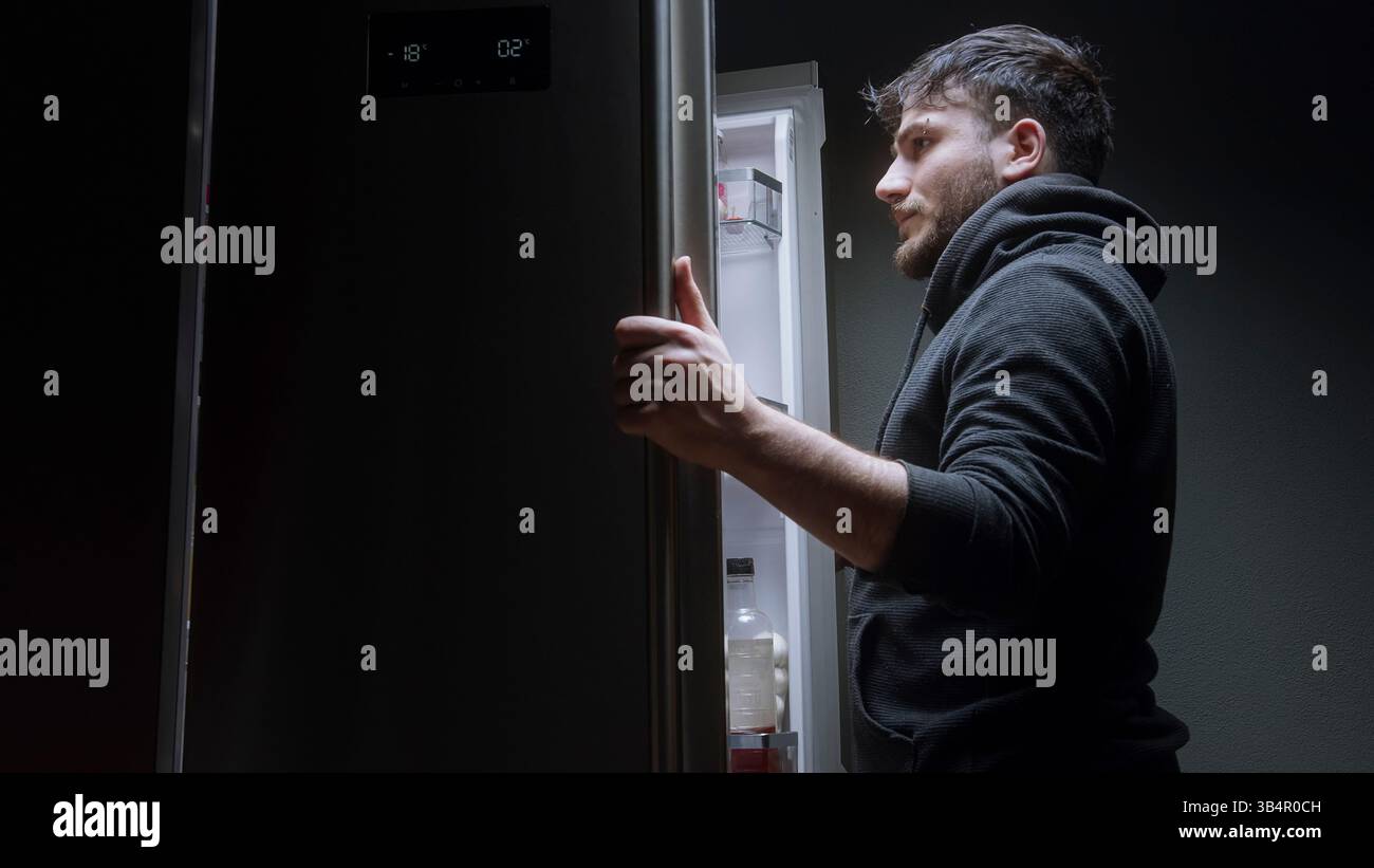 Man Searching for Food in Refrigerator and Not Finding What He Wants at ...