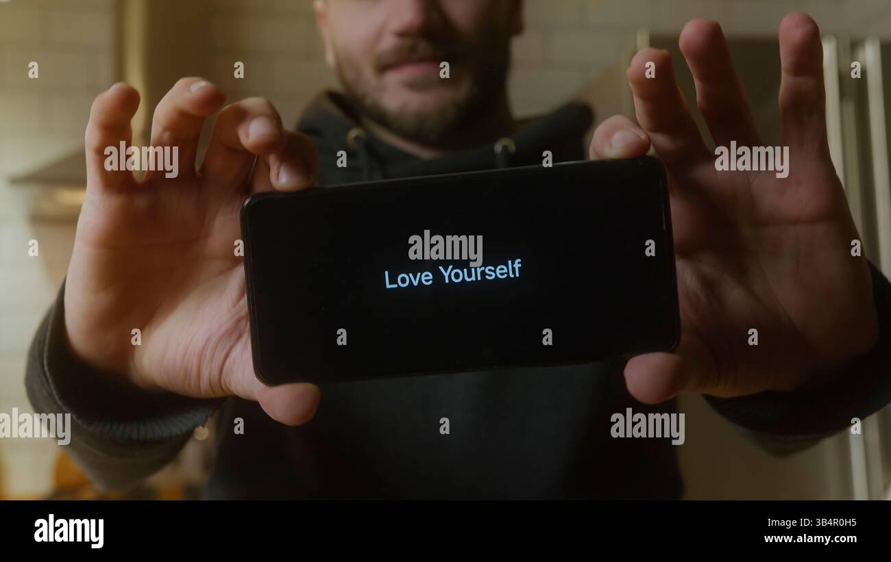 Happy Man Holding Smartphone with Motivational Message Love Yourself ...